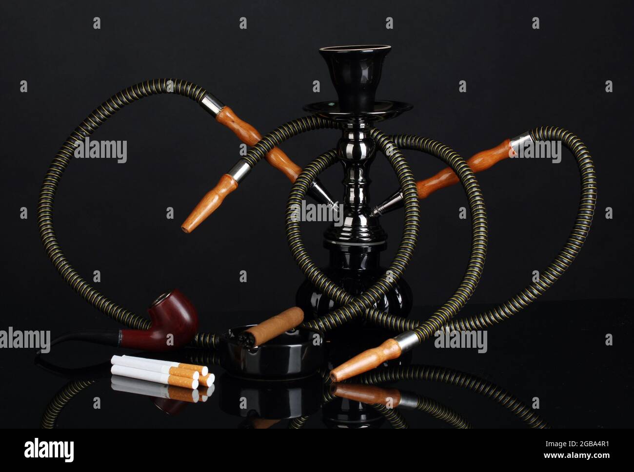 Smoking tools - a hookah, cigar, cigarette and pipe isolated on black ...
