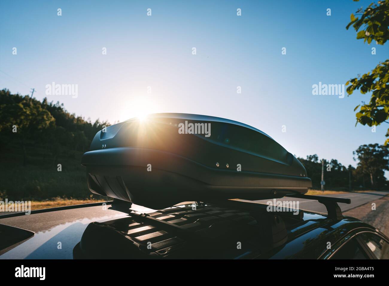 Car with black plastic rooftop cargo box or roof carrier for traveling ...