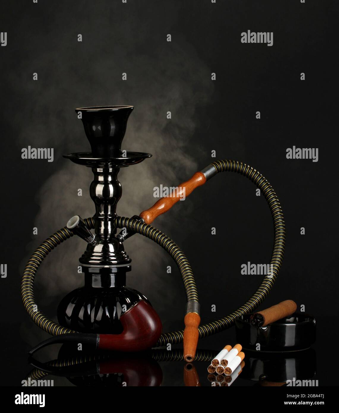 Smoking tools - a hookah, cigar, cigarette and pipe on black background ...