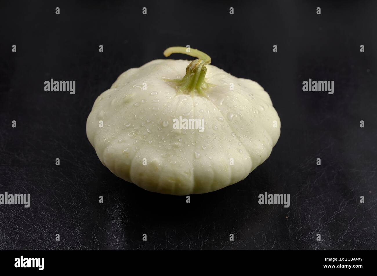 Minimalist composition with one Pattypan squash on the black background ...