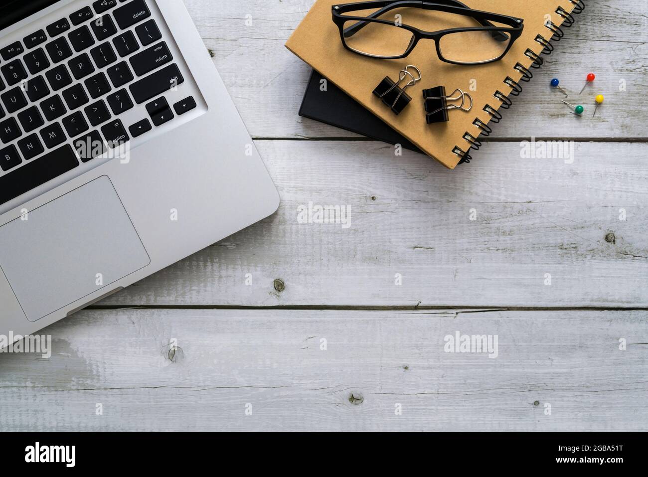 Laptop and notebook on white wood table for business office work desk ...