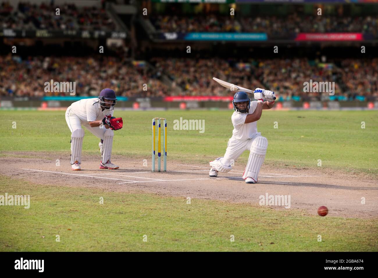 Cricketer batsman hitting a shot during a match on the pitch Stock ...