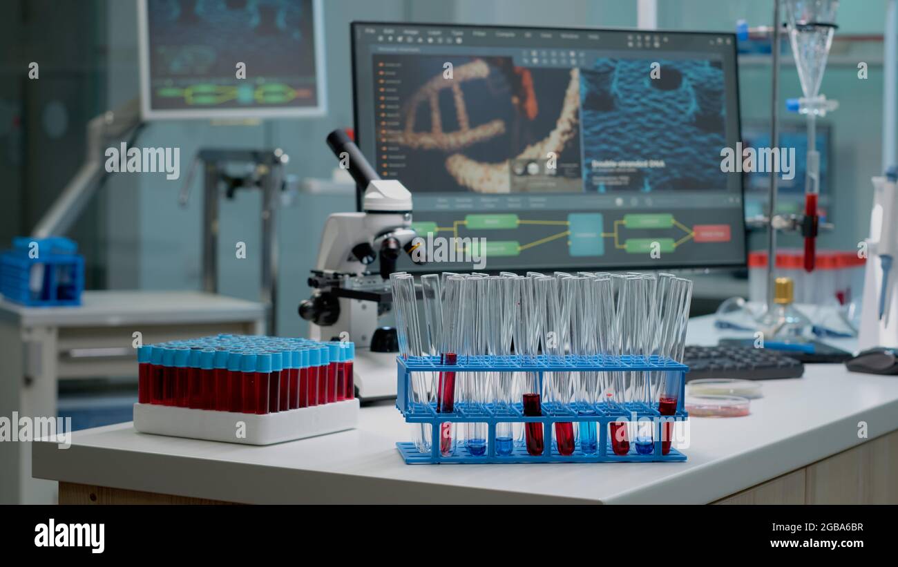 Medical test tubes with blood on desk in laboratory at research clinic ...