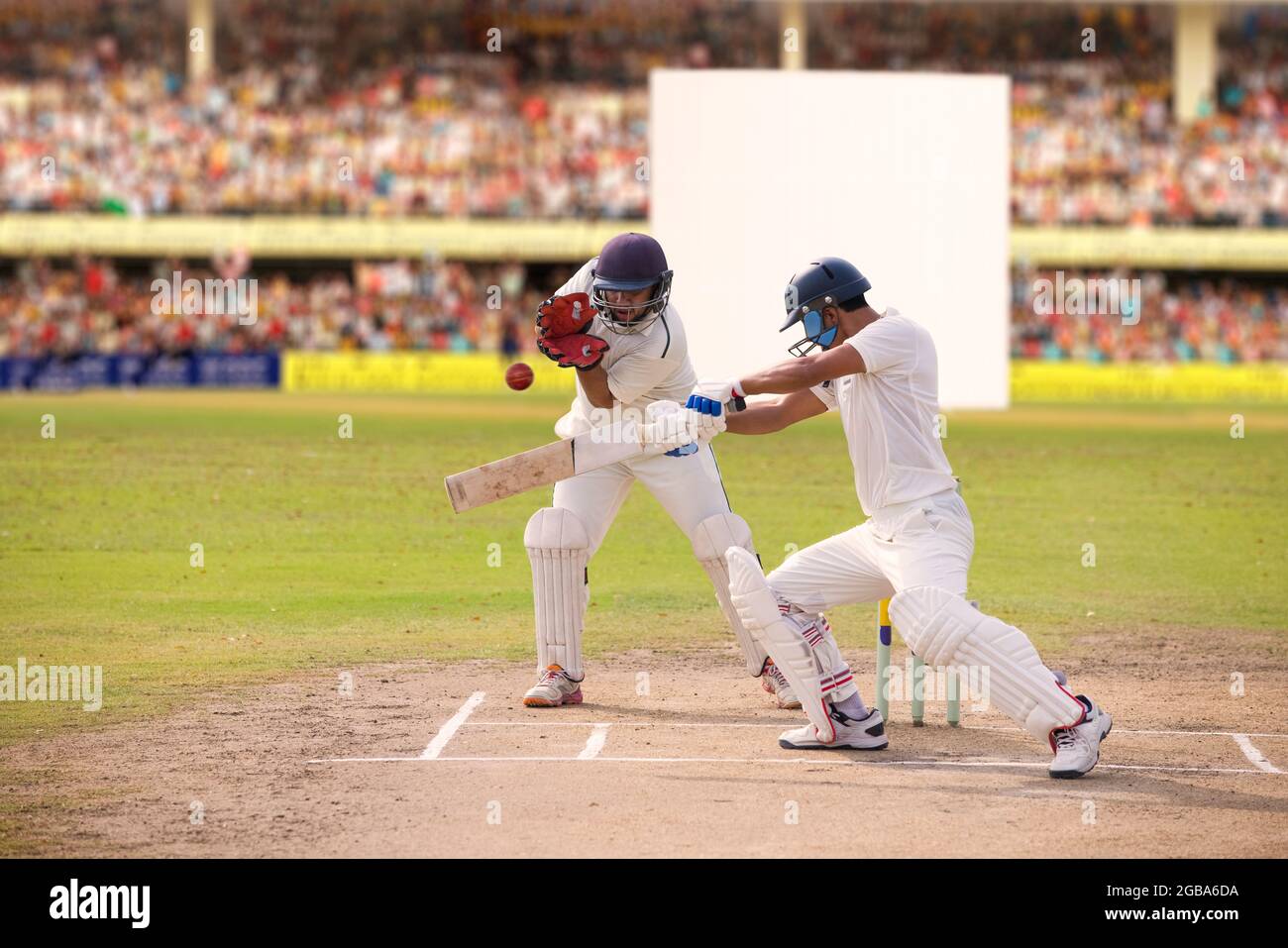 Cricketer batsman hitting a shot during a match on the pitch Stock ...