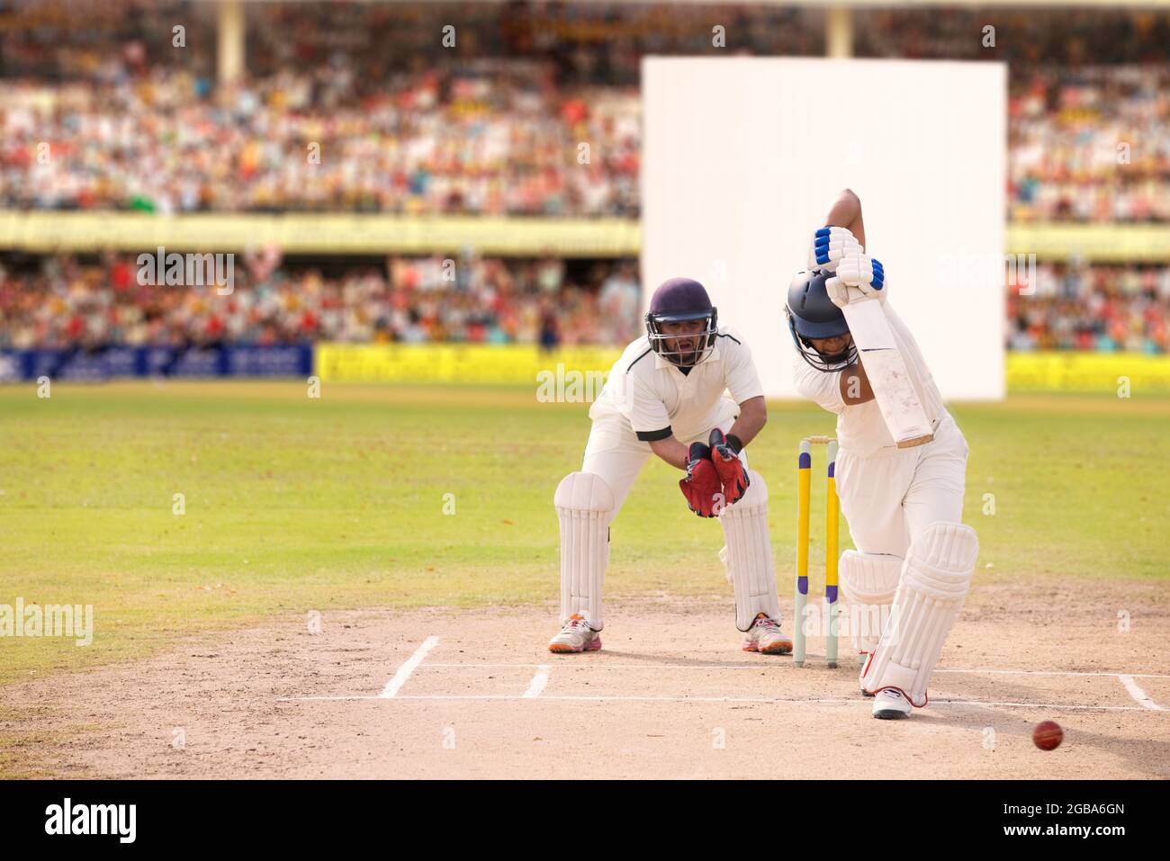 Cricketer batsman hitting a shot during a match on the pitch Stock ...