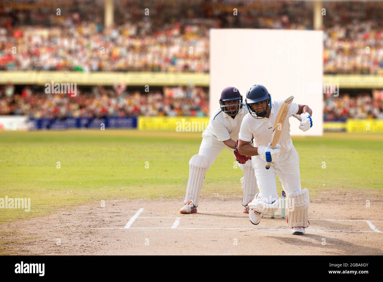 Batsman taking a run during a match Stock Photo - Alamy