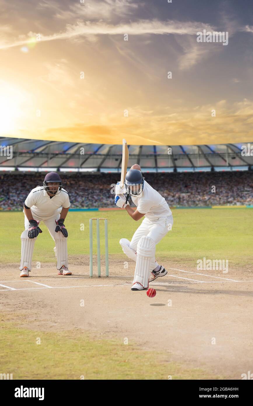 Cricketer batsman hitting a shot during a match on the pitch Stock ...
