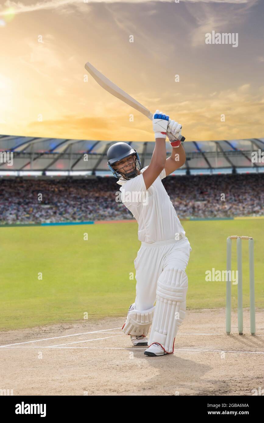 Cricketer batsman hitting a shot Stock Photo - Alamy