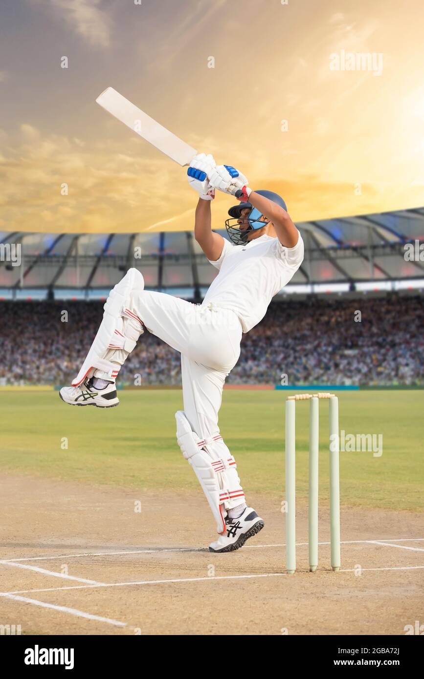 Cricketer batsman hitting a shot Stock Photo - Alamy