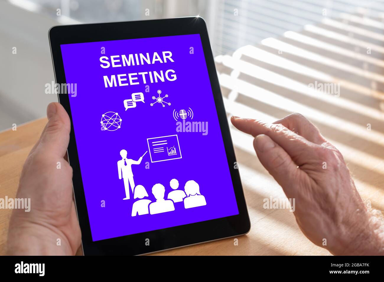 Tablet screen displaying a seminar meeting concept Stock Photo - Alamy