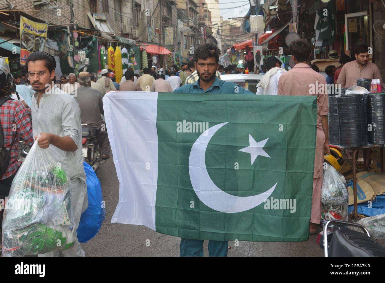 Pakistani people visit in a busy market where different stuff displayed ...