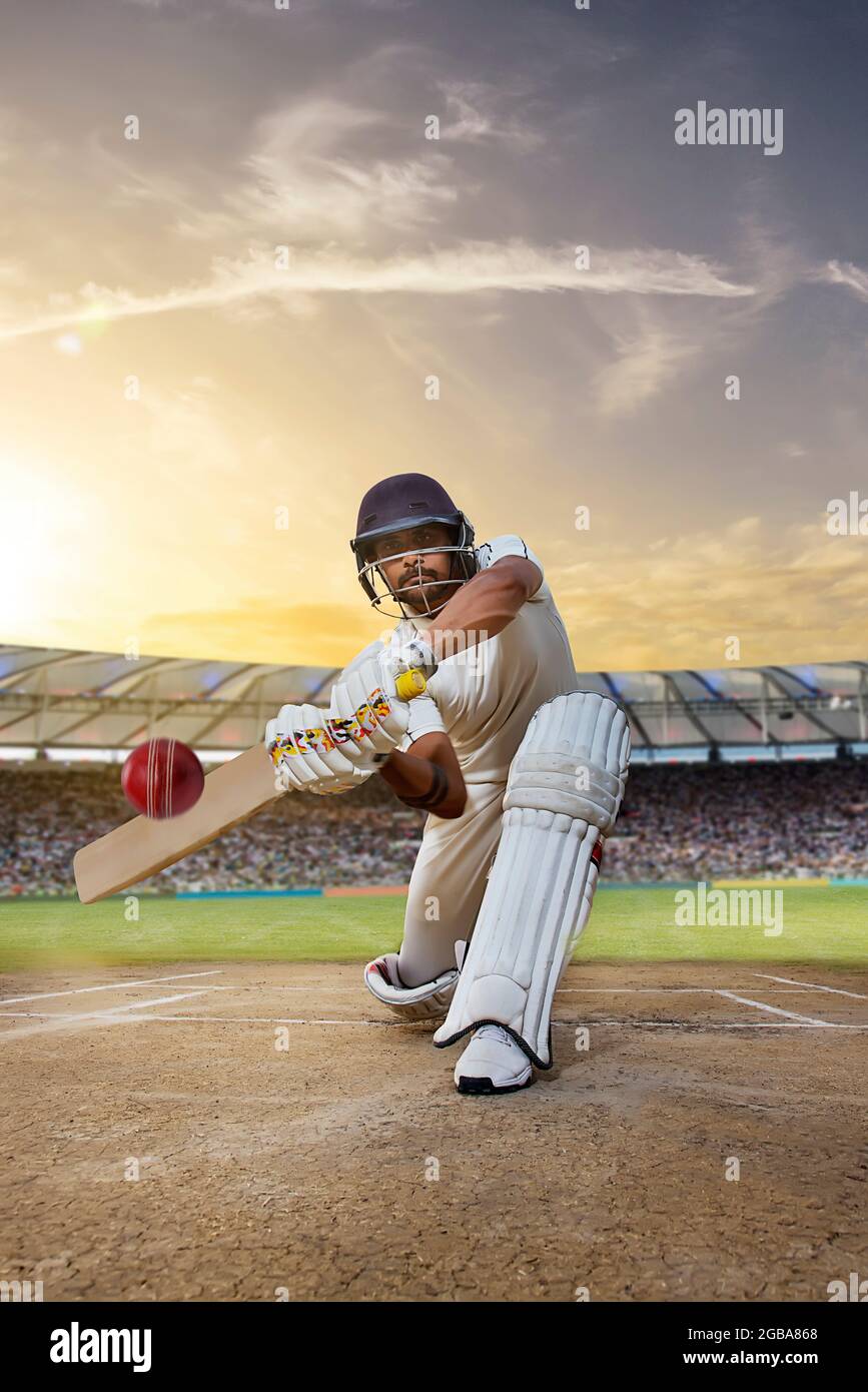 Cricketer batsman hitting a shot during a match on the pitch Stock ...