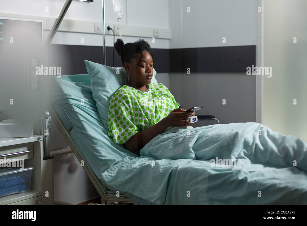 Young african american adult with sickness having smartphone in hand ...