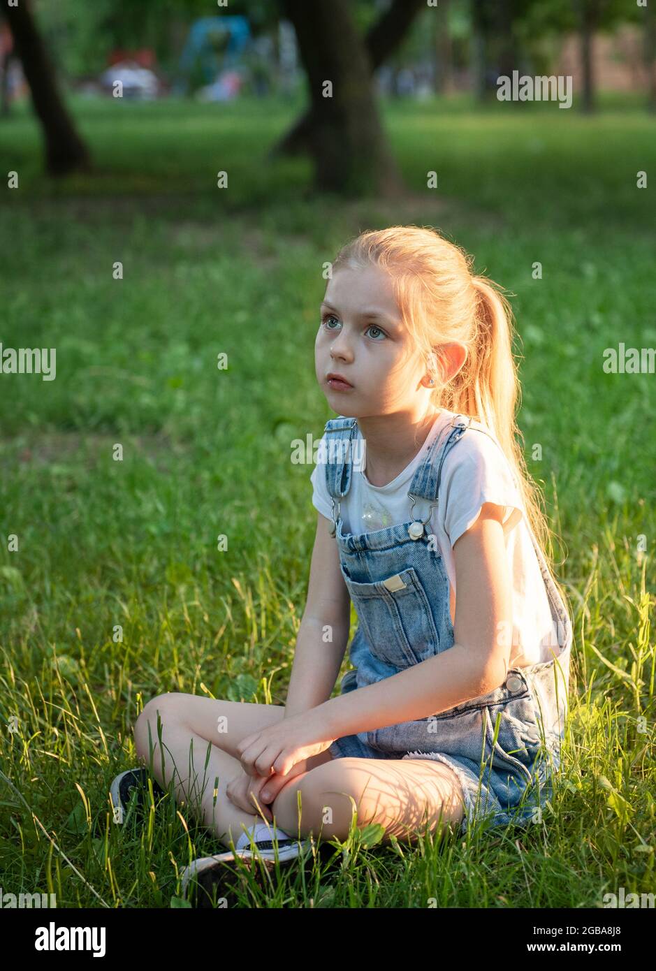 Sad girl sitting alone playground hi-res stock photography and images - Alamy