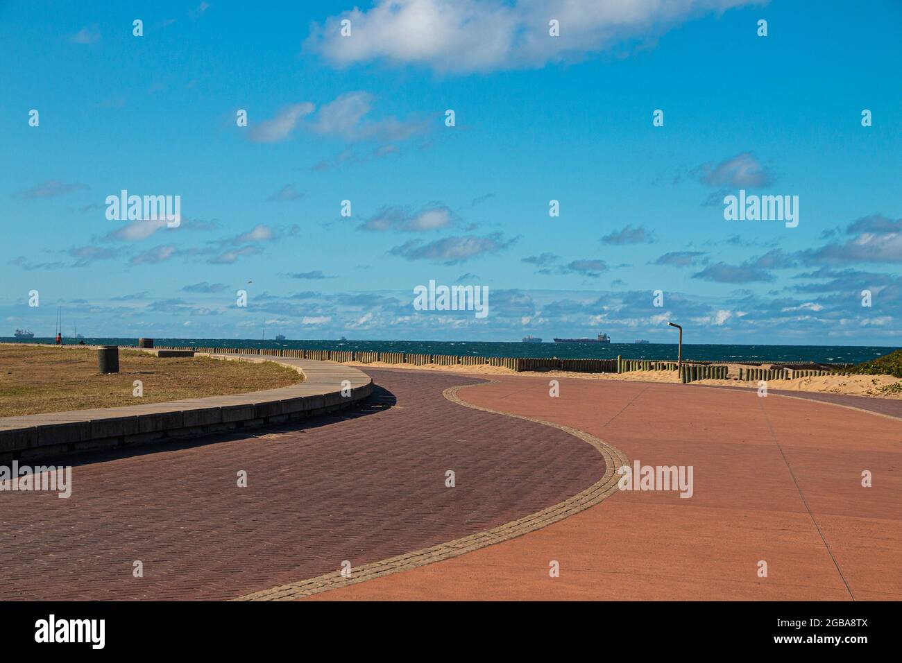 Attractive paved pedestrian walkway leading onto beach Stock Photo - Alamy
