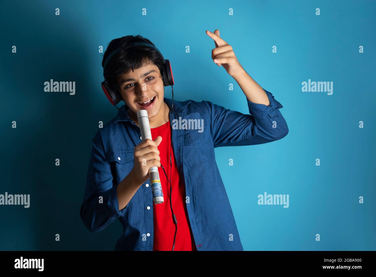 A TEENAGE BOY DANCING AND SINGING WHILE LISTENING TO MUSIC Stock Photo ...