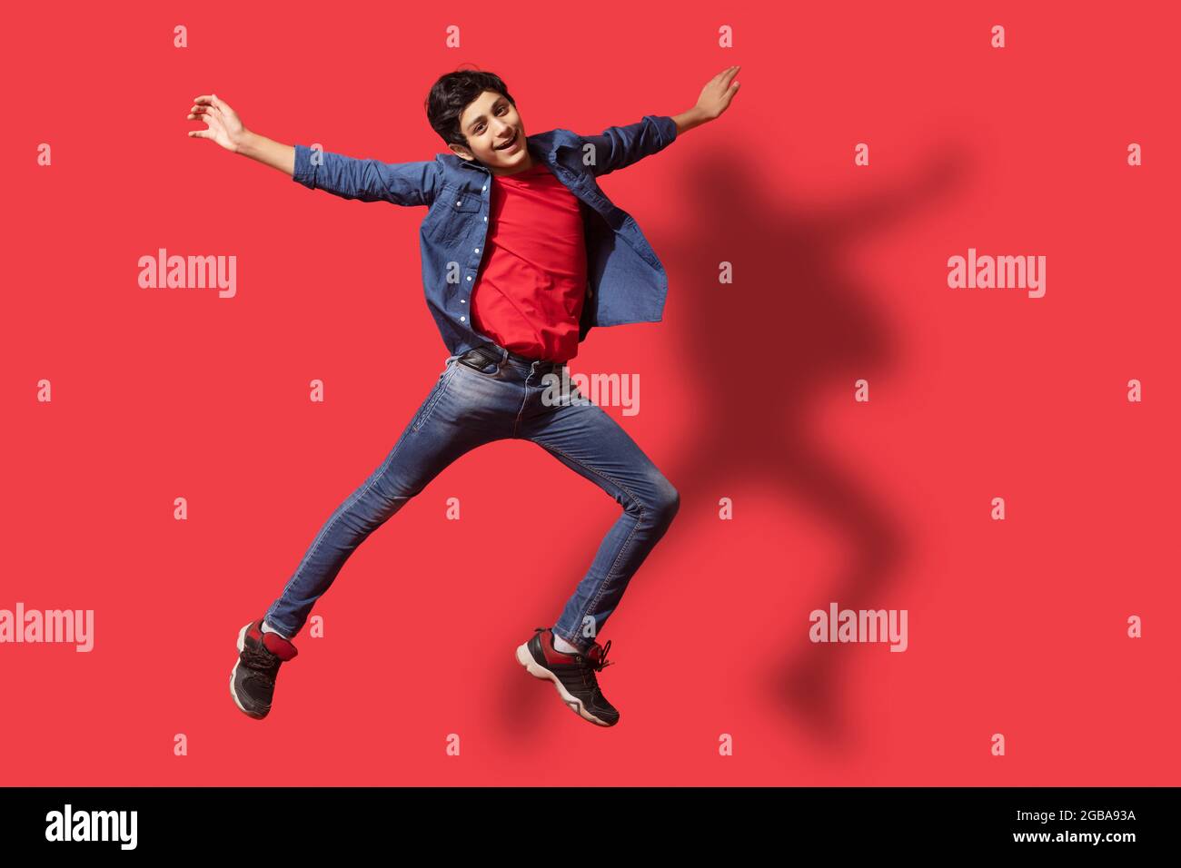 A TEENAGE BOY EXCITEDLY JUMPING Stock Photo - Alamy