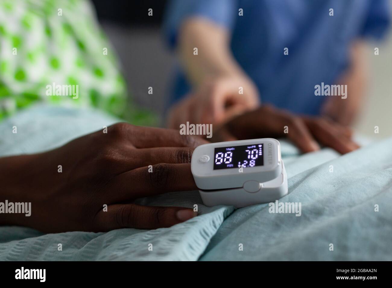 Close up of oximeter on african american girl hand laying in hospital ...