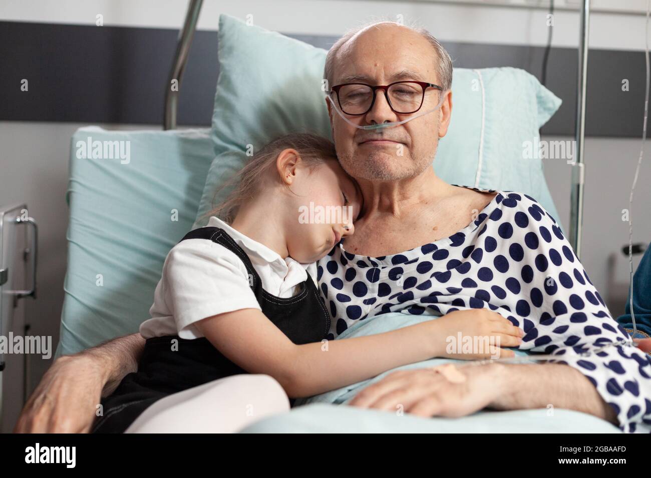 Caring grandchild hugging sick elderly grandparent showing love during ...