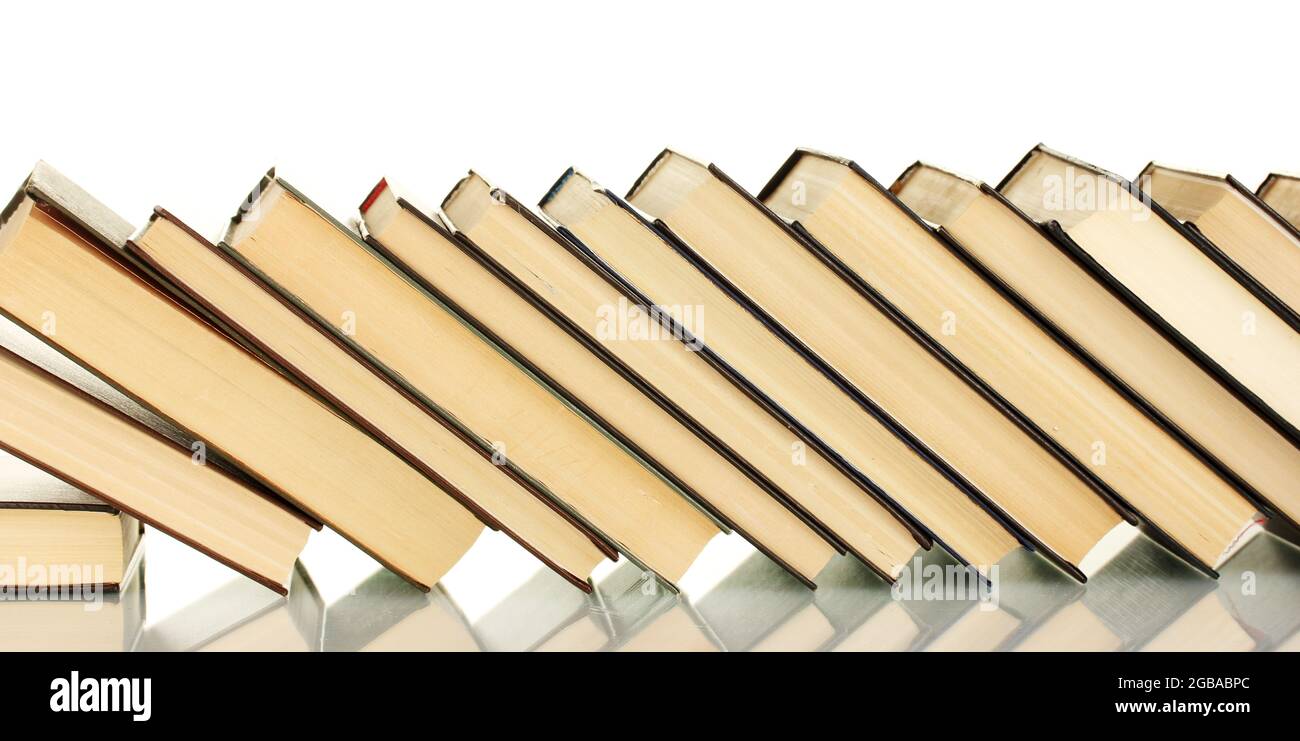 leaning stack of books on white background Stock Photo - Alamy