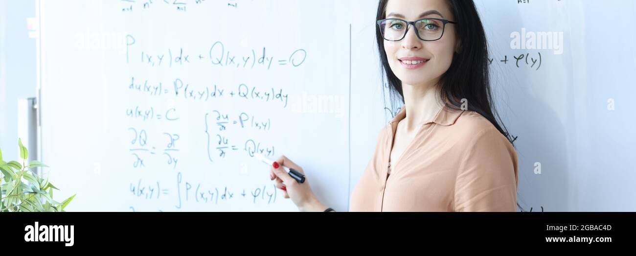 Young woman teacher stands at white board Stock Photo - Alamy Young woman teacher stands at white board Stock Photo - Alamy
