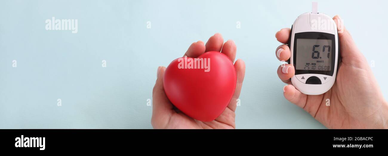 Small heart and glucometer with indicators held in hand Stock Photo - Alamy