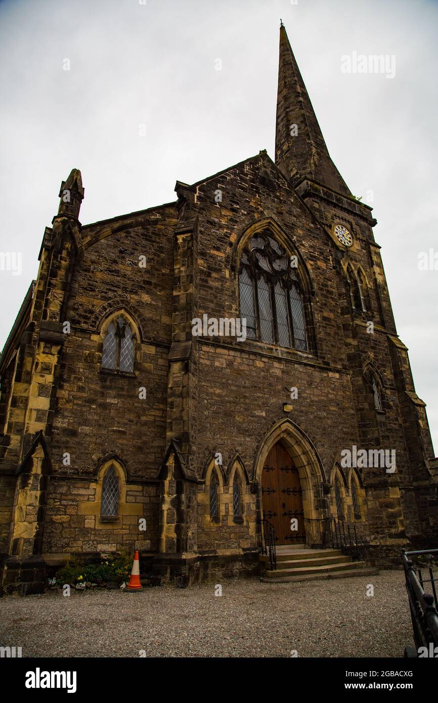 Weathered yellow stone picturesque church facade Stock Photo - Alamy