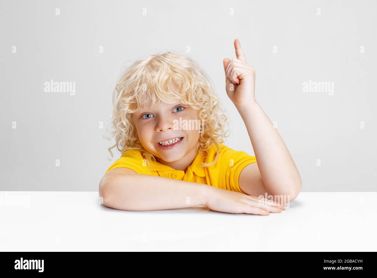 Portrait of one cute little curly preschool boy in casual clothes ...