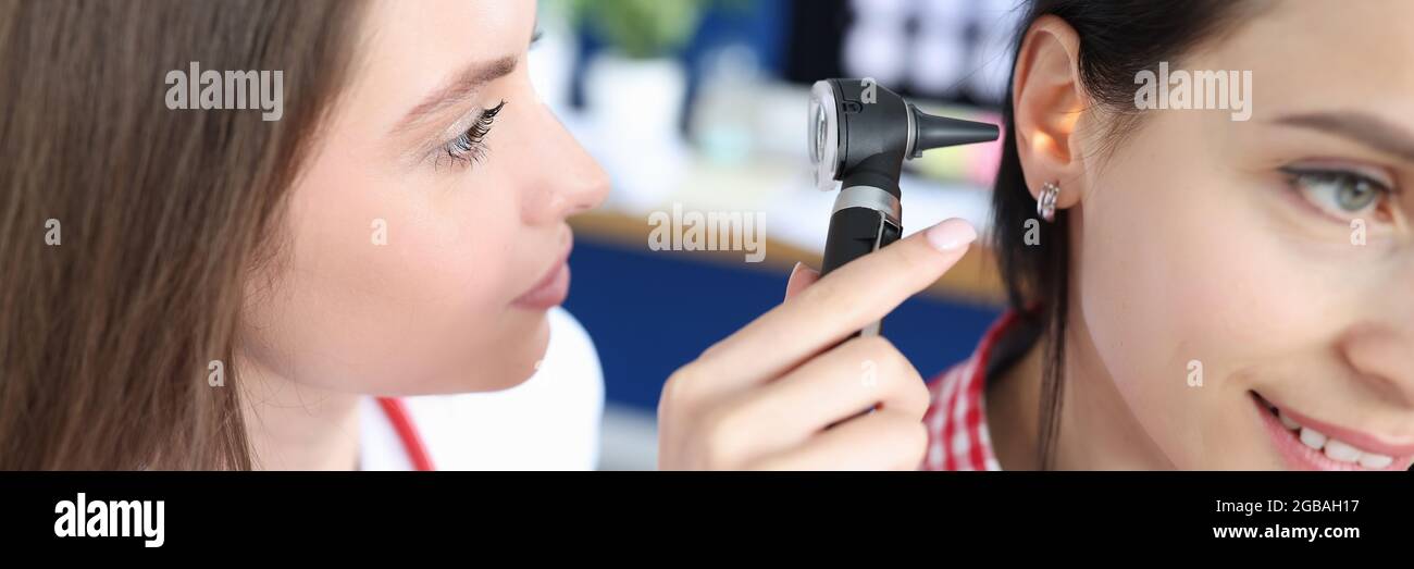 Otorhinolaryngologist examines patient ear with otoscope closeup Stock ...