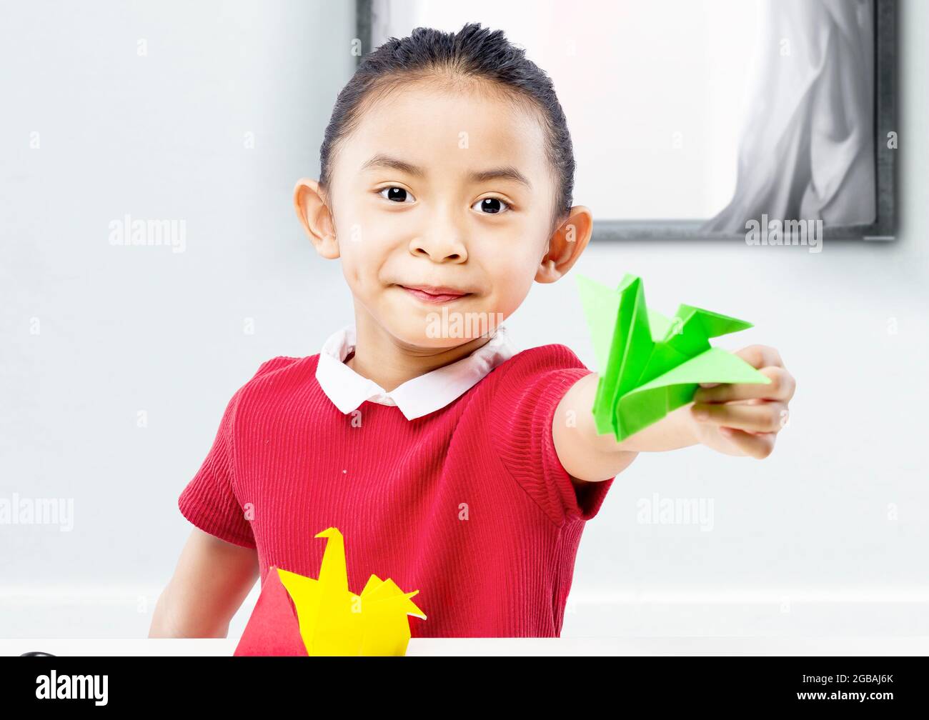 Asian little girl showing her goose paper at home Stock Photo - Alamy