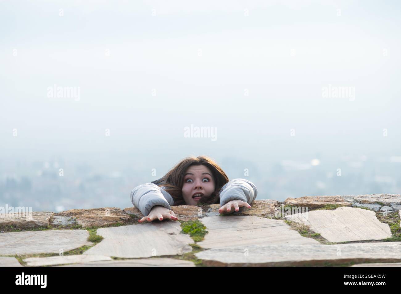 Young woman falling off from a mountain hill Stock Photo - Alamy