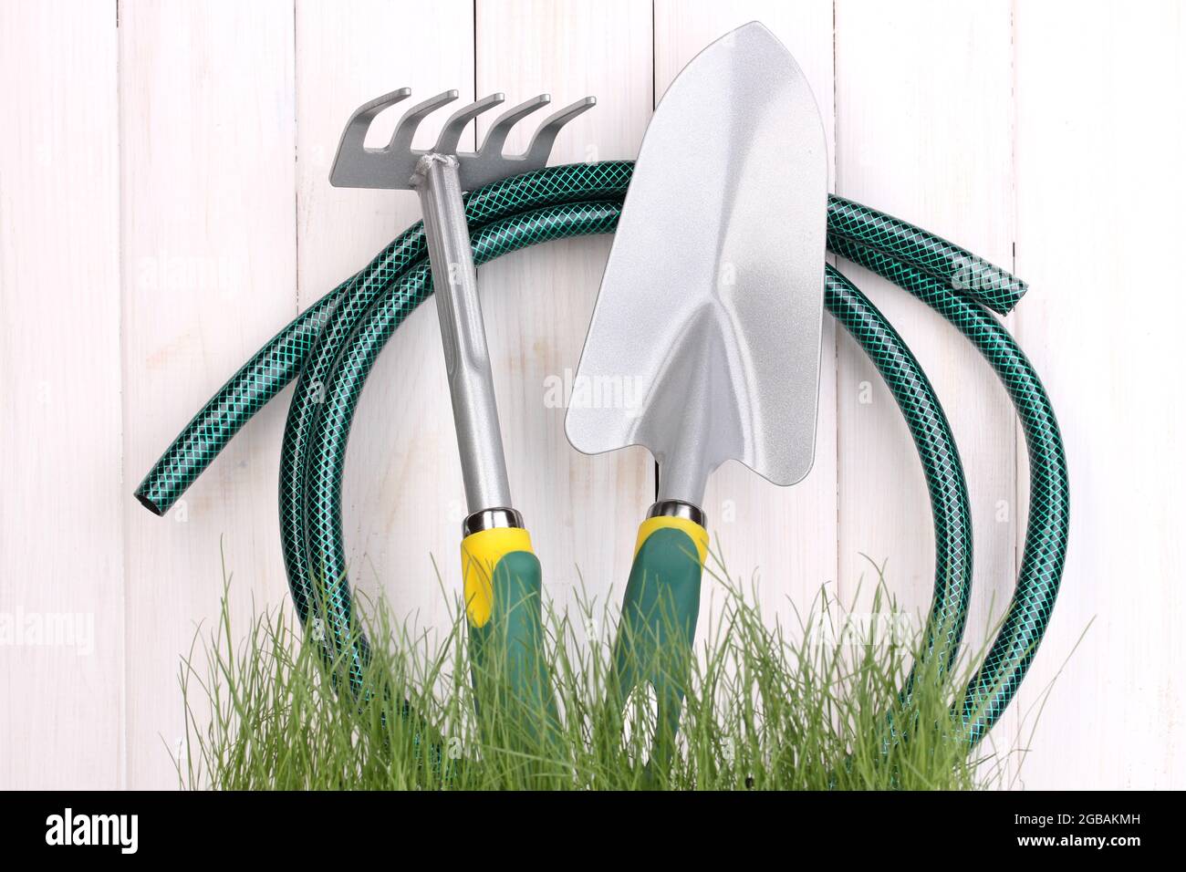 Green grass and garden tools on wooden background Stock Photo - Alamy