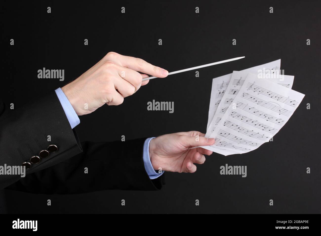 Music conductor hands with baton and notes isolated on black Stock ...