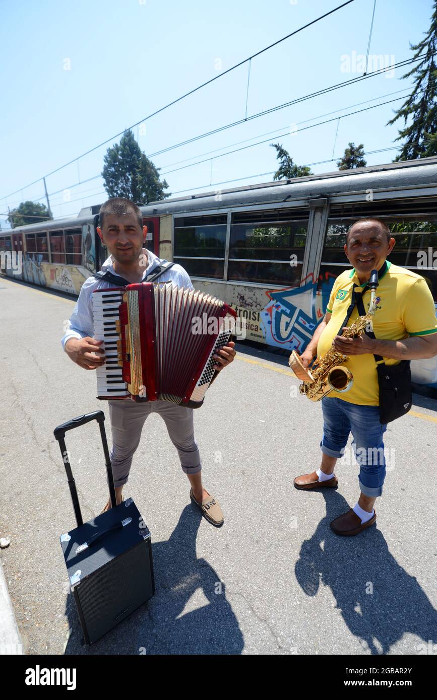 A musician playing his accordion on the train station platform in ...
