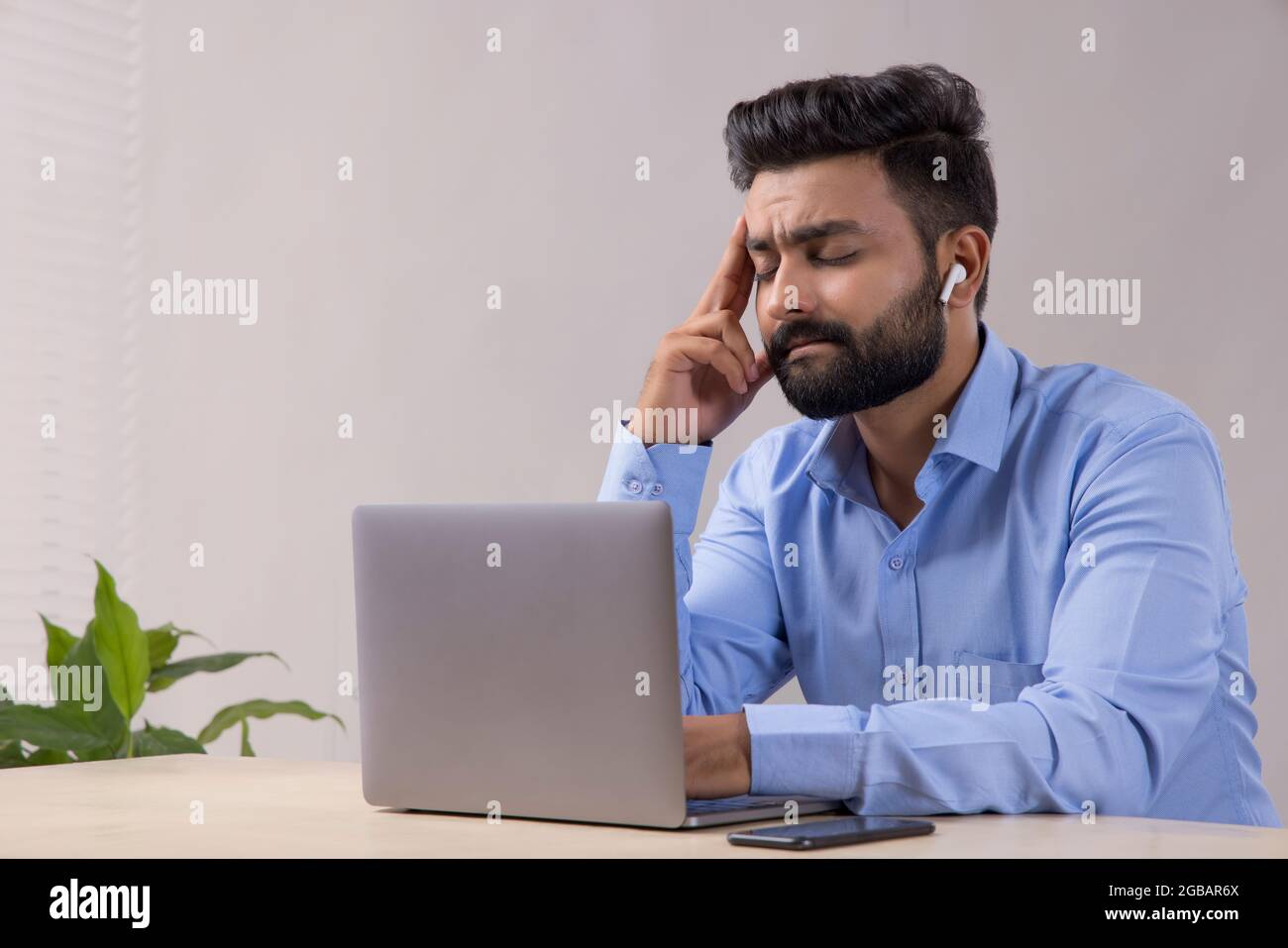 A YOUNG MAN SITTING AND THINKING WHILE WORKING Stock Photo - Alamy