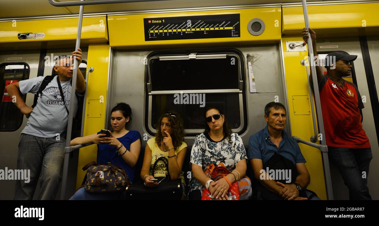 Passengers sitting in line 1 in Naples metro Stock Photo - Alamy