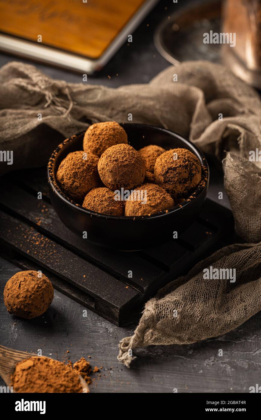 Homemade delicious cocoa balls with healthy ingredients in a black ...