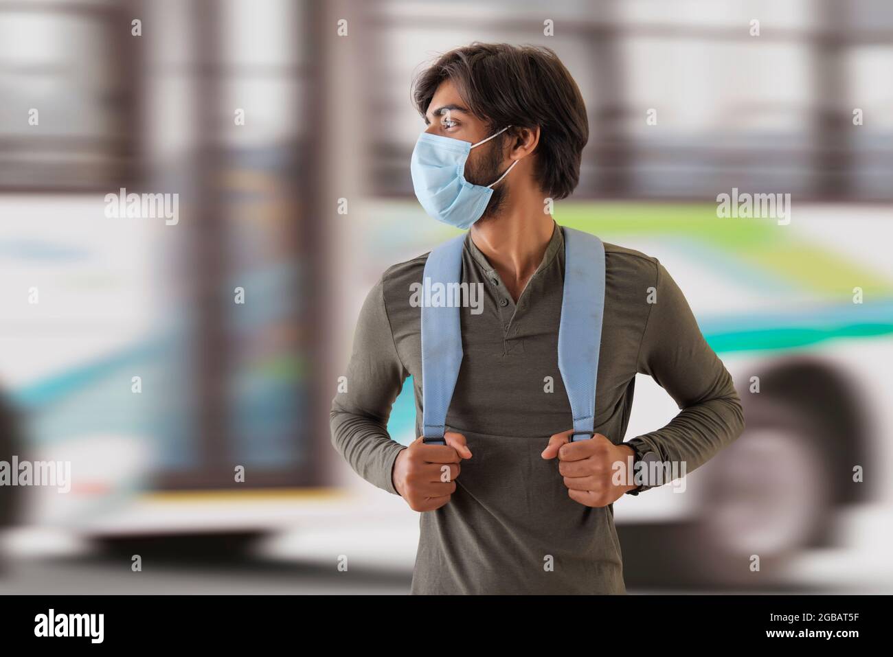 A young student with face mask standing in front of a bus Stock Photo ...