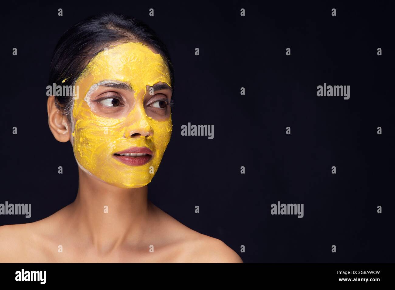 A young woman's face with home made face mask applied for skin care ...