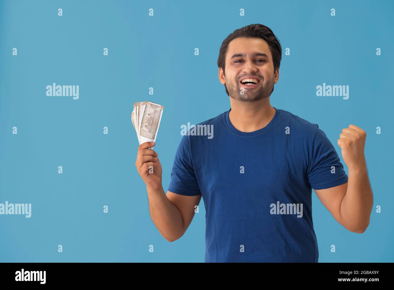Happy smiling indian man holding indian money hi-res stock photography ...