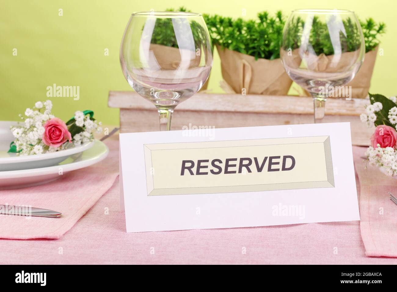 Table setting with reserved card in restaurant Stock Photo - Alamy