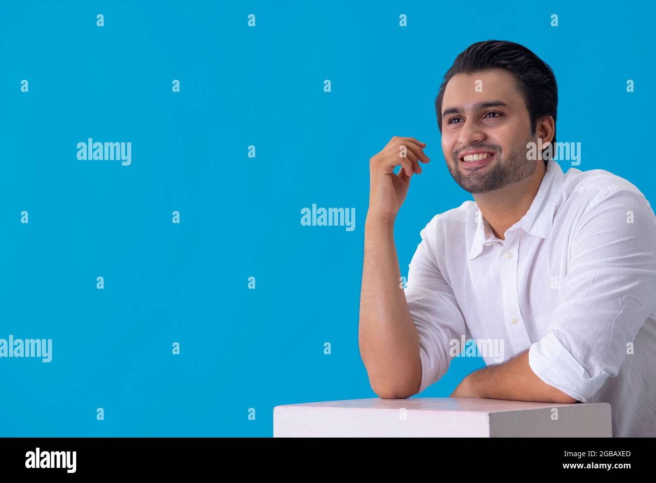 Portrait of a young man smiling while thinking something Stock Photo ...