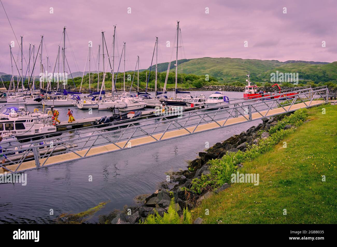 An overcast June day and work goes on in the Craobh Marina Stock Photo ...