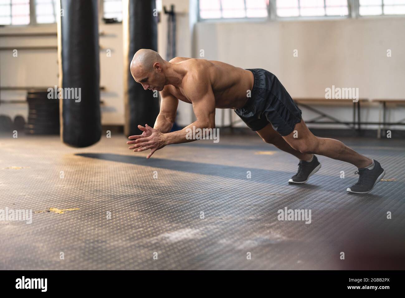 Strong caucasian man exercising at gym, doing push-ups Stock Photo - Alamy