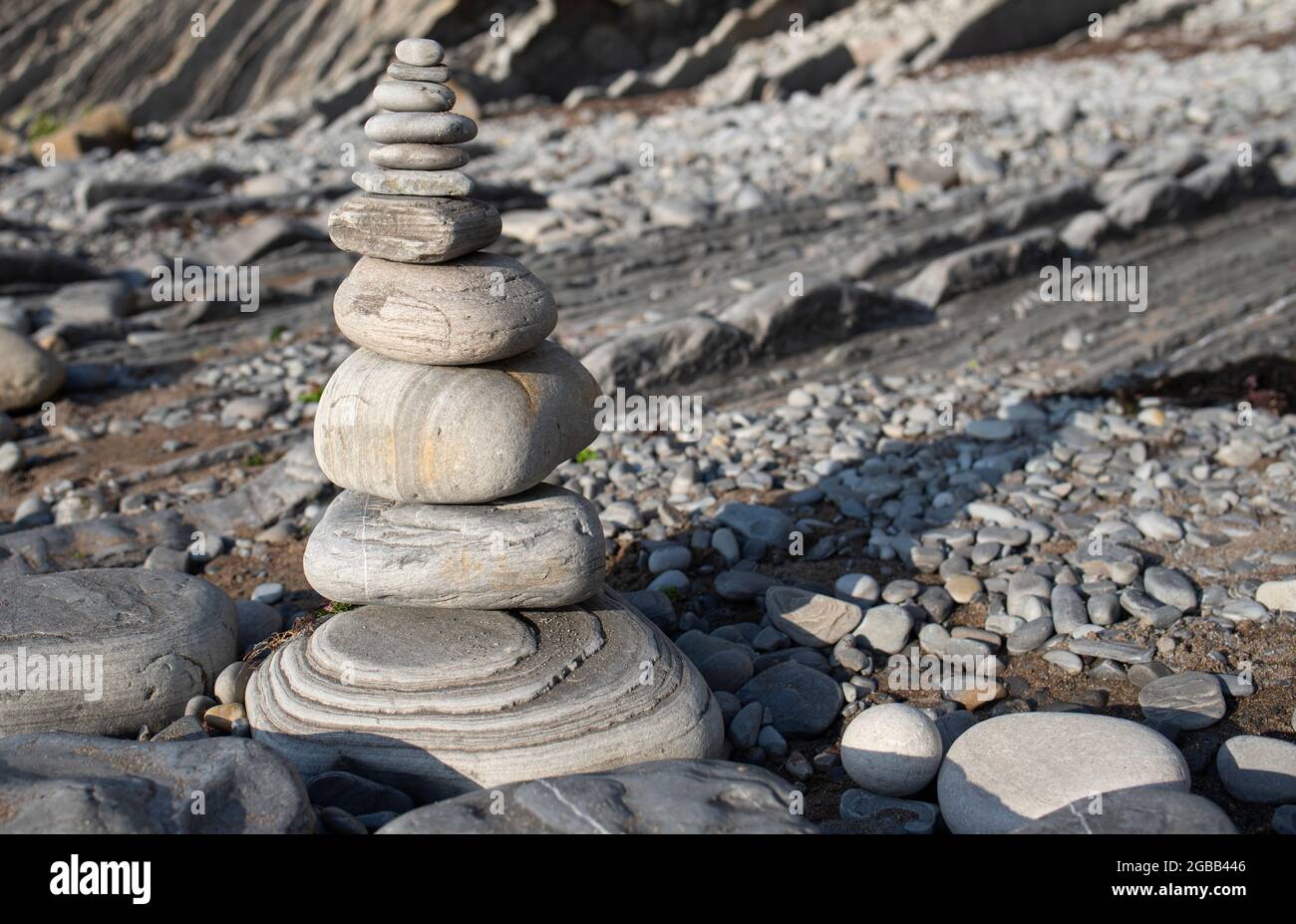 Balanced stones on a pebble beach Stock Photo - Alamy