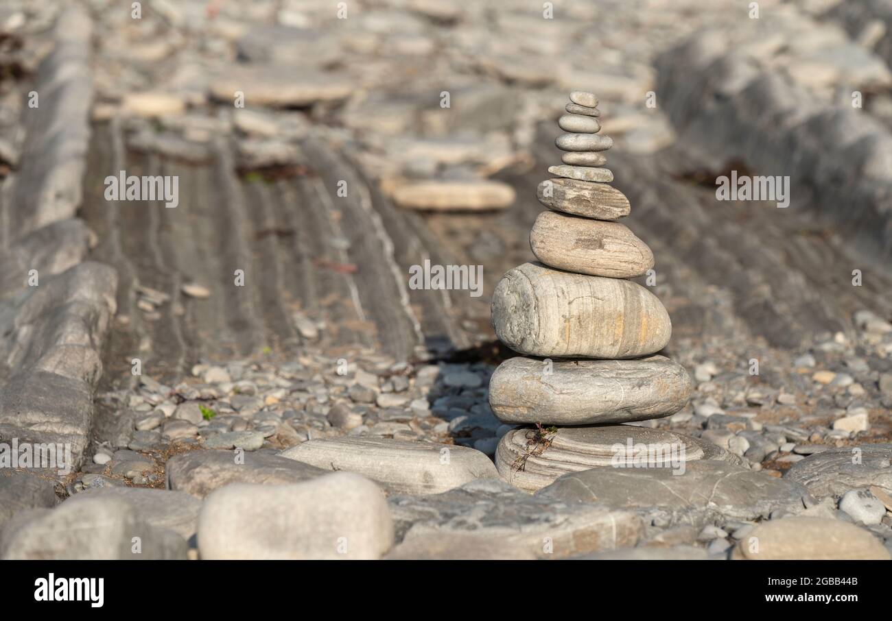 Balanced stones on a pebble beach Stock Photo - Alamy