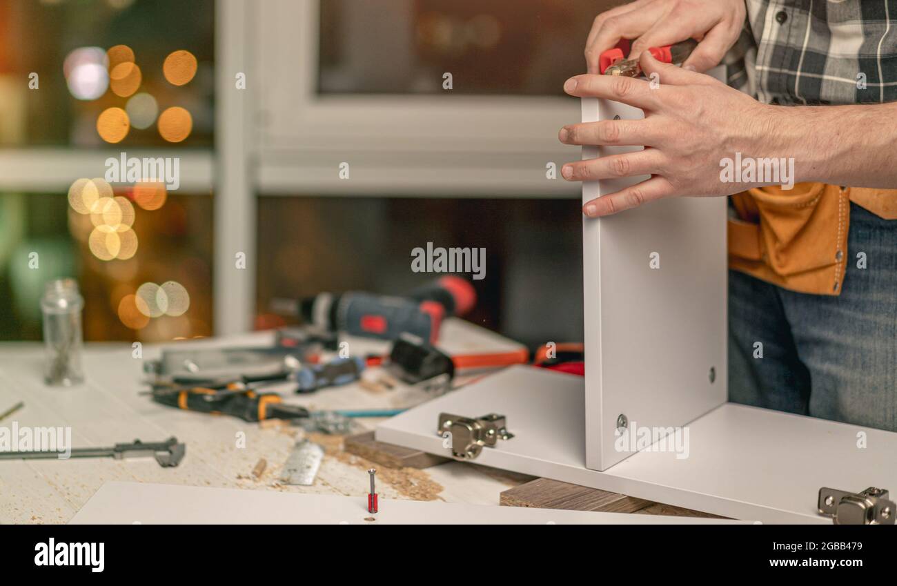 Man working during process of furniture manufacturing Stock Photo - Alamy