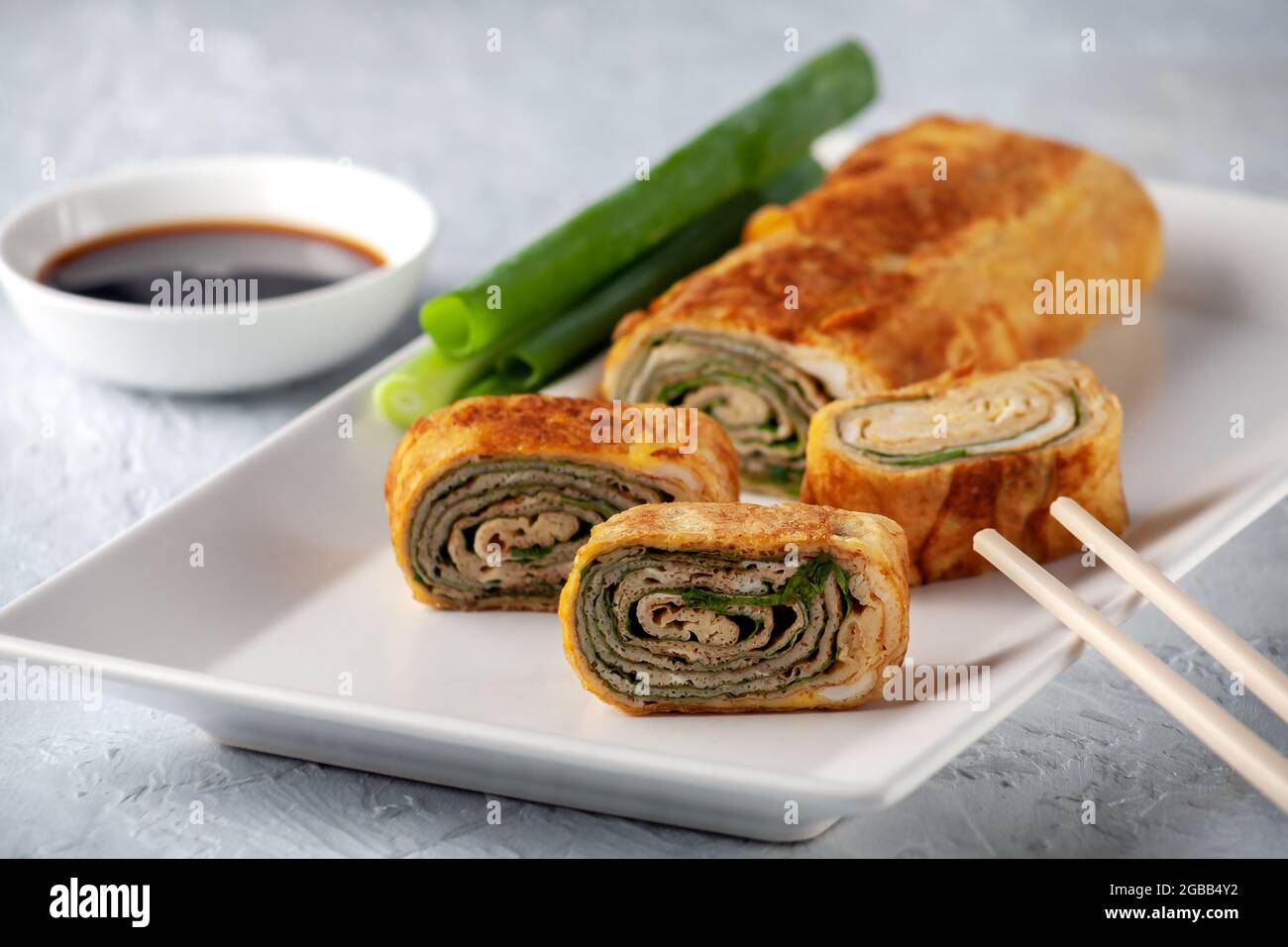 Japanese kitchen. Tamagoyaki - Japanese omelet, rolled several layers ...