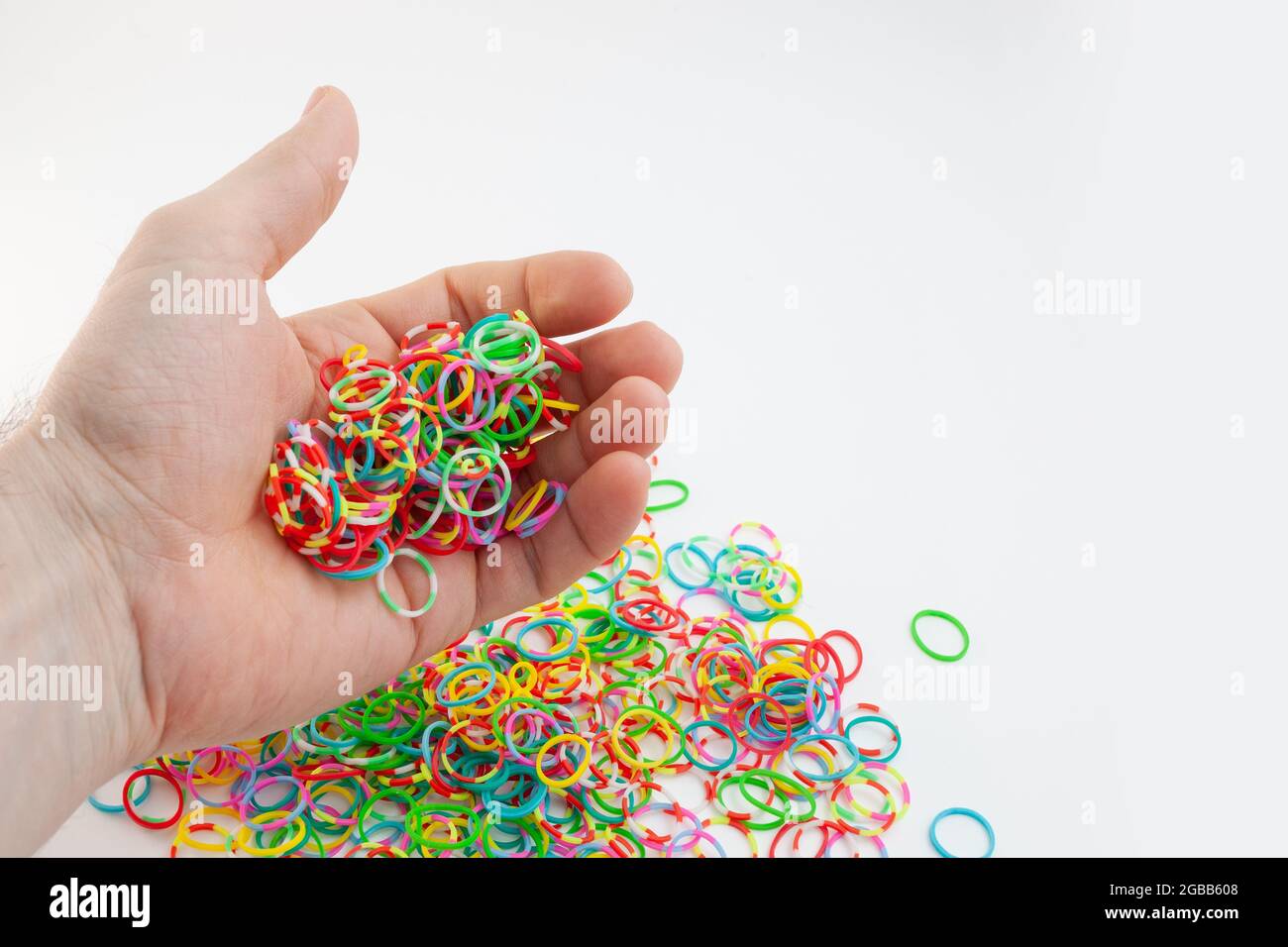 Isolated Color rubber band in hand Stock Photo - Alamy