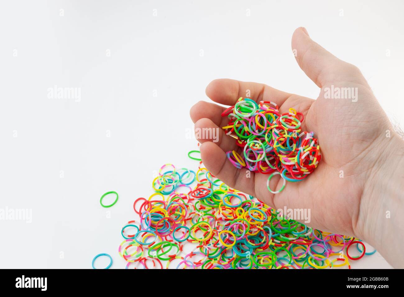 Isolated Color rubber band in hand Stock Photo - Alamy